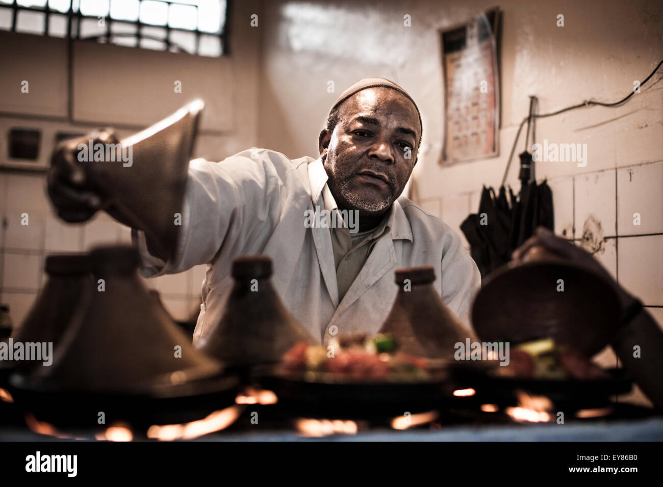 Man preparing traditional food, tajine, restaurant, Agadir, Morocco ...