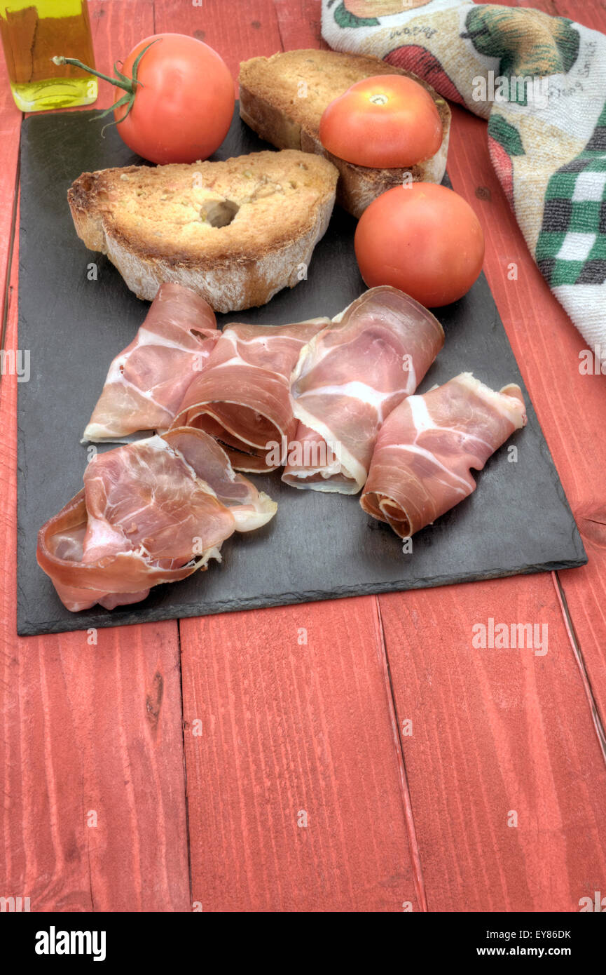 a vertical view of a traditional mediterranean dish, pan tumaca with ...