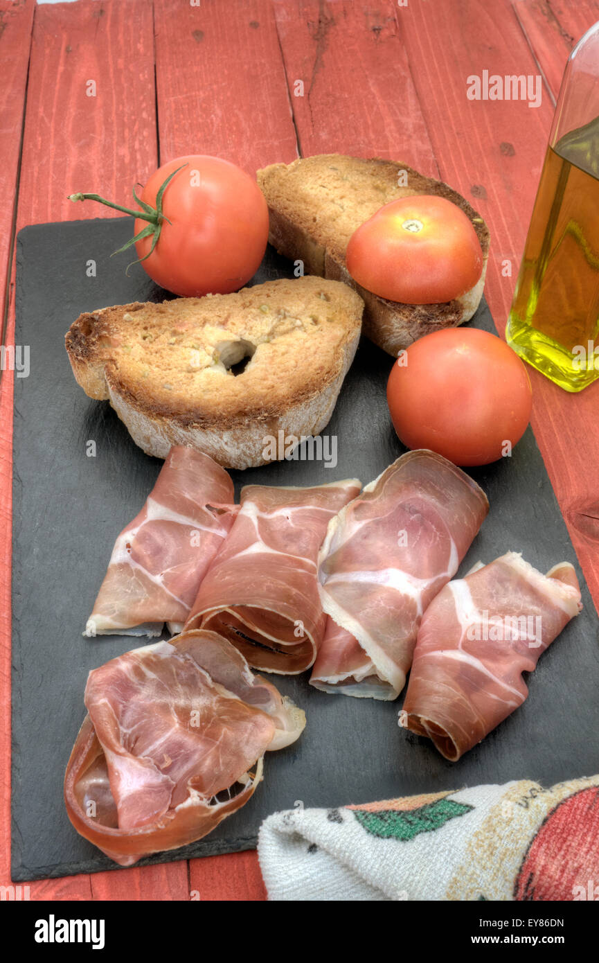 a vertical view of a traditional mediterranean dish, pan tumaca with ...