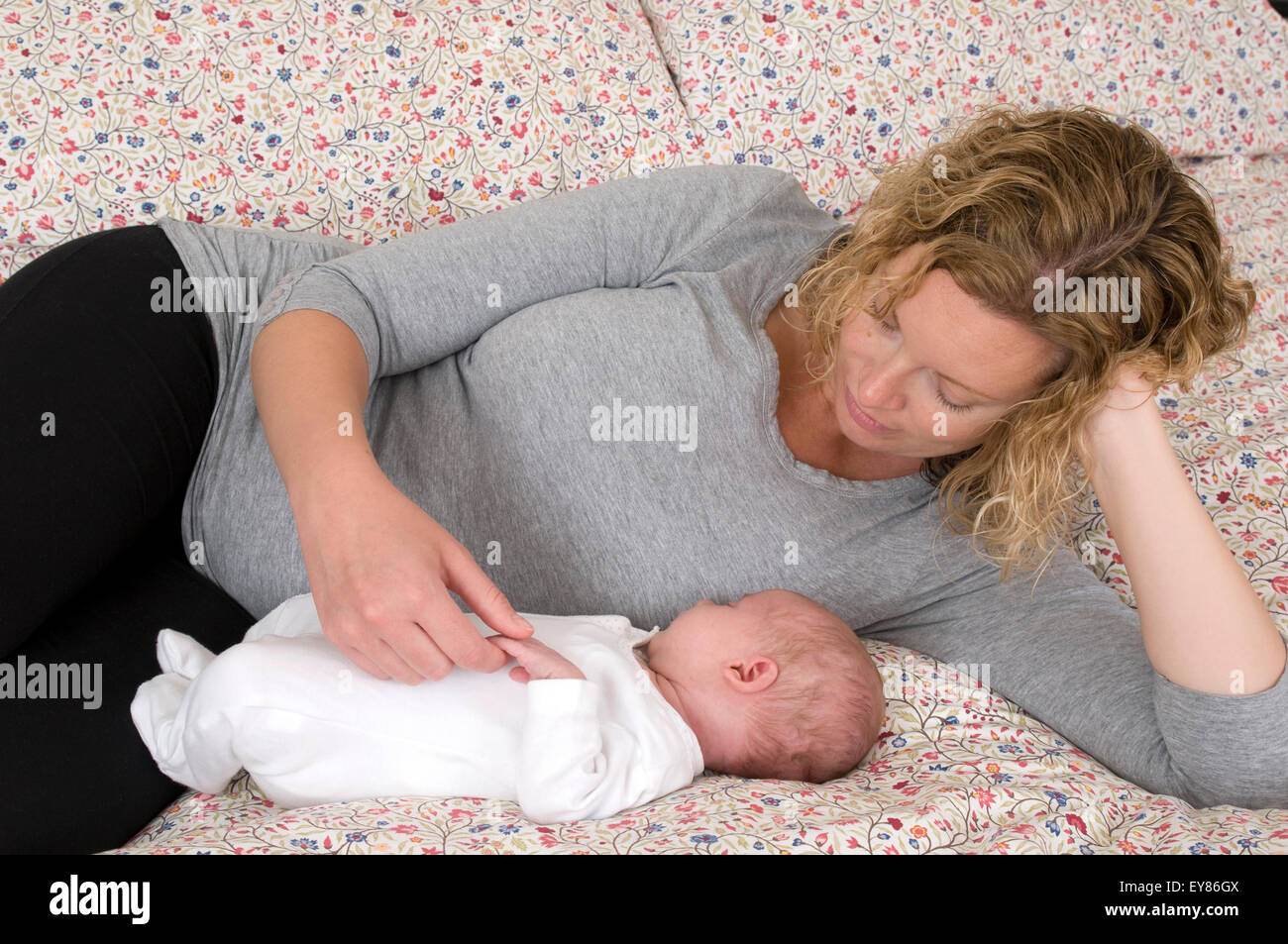 Mum cuddling her newborn baby Stock Photo - Alamy