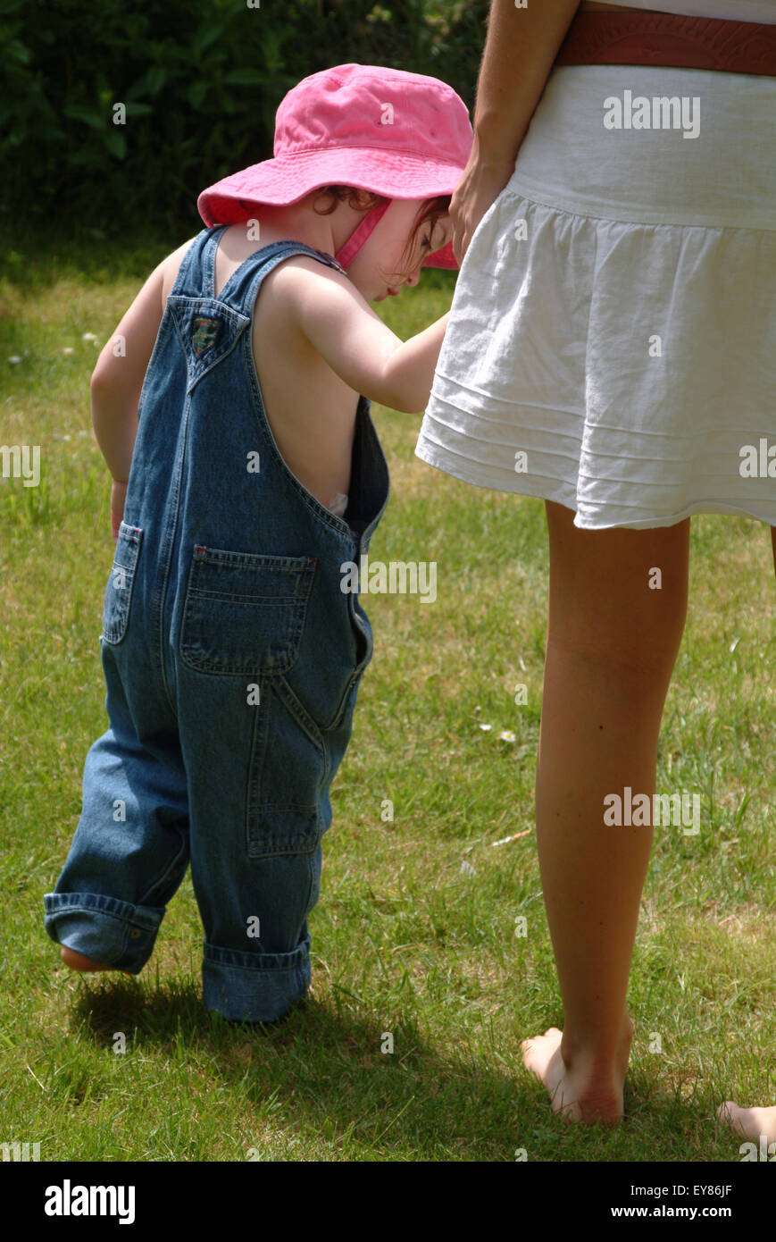 Rear view of toddler holding hands with her mother Stock Photo - Alamy