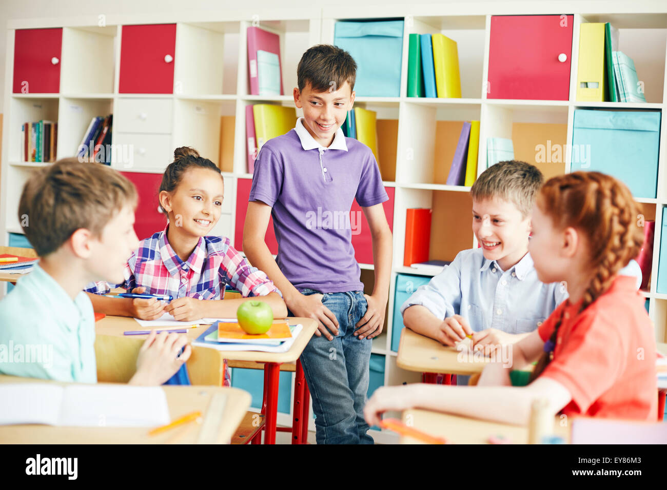 Friendly classmates chatting at break Stock Photo - Alamy