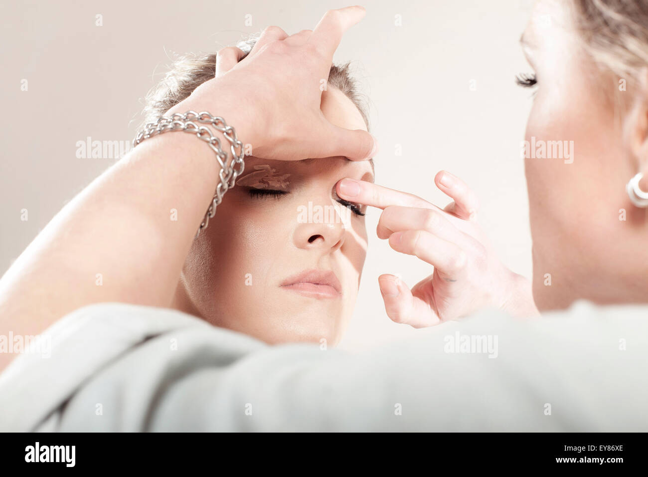 Makeup artist applying makeup on models face, close-up Stock Photo - Alamy