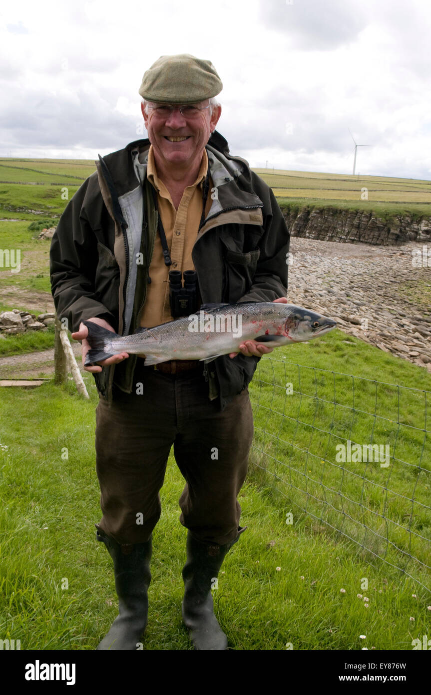 Portrait of happy angler, smiling holding his salmon Stock Photo - Alamy