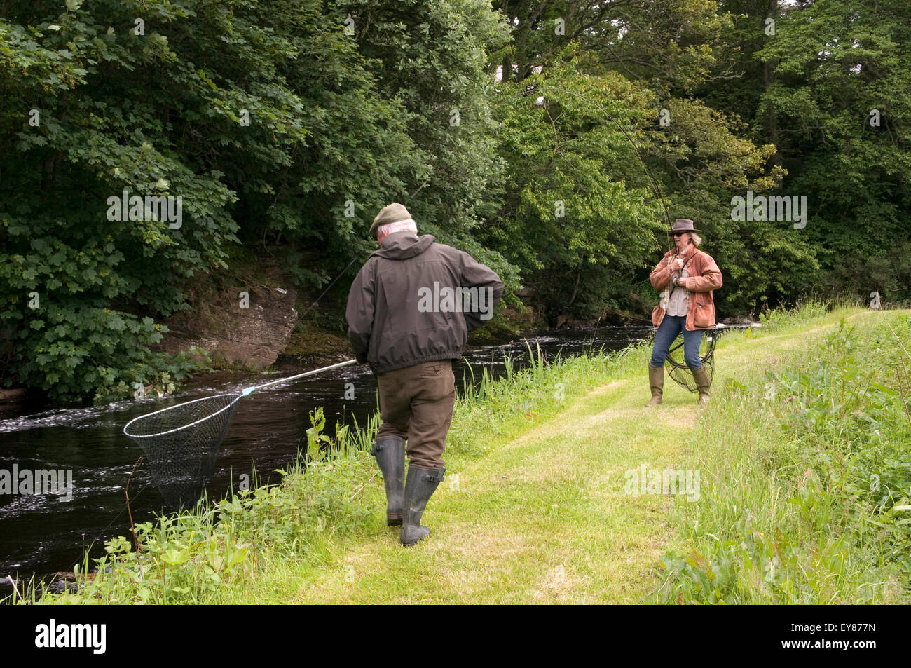Woman angler reeling fish hi-res stock photography and images - Alamy