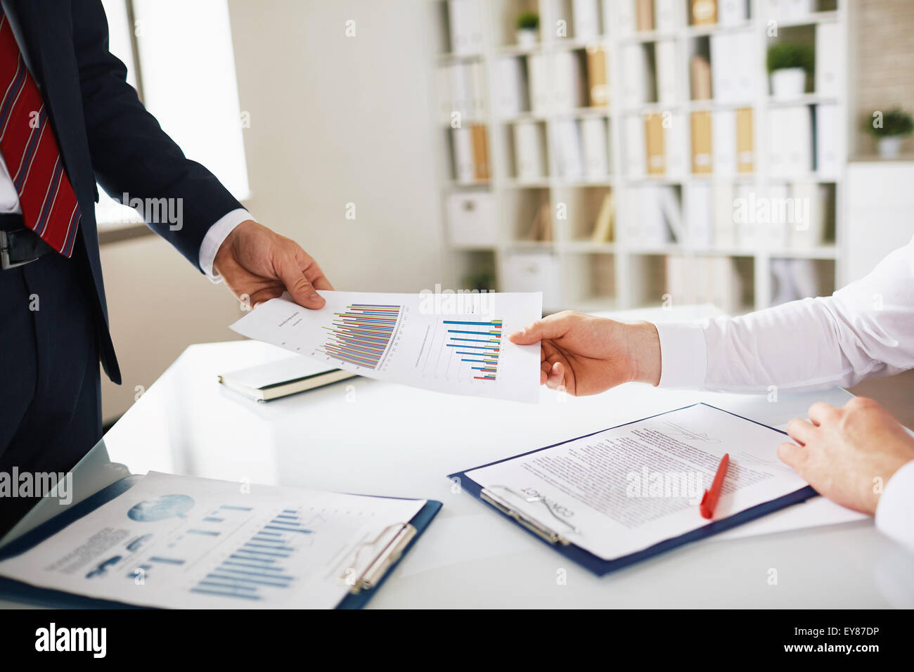 Businessman giving financial document hi-res stock photography and ...