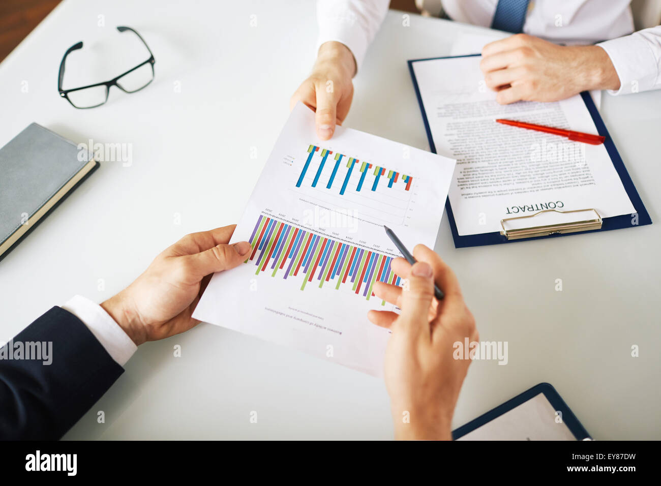 Businessman giving and explaining financial report to boss Stock Photo ...