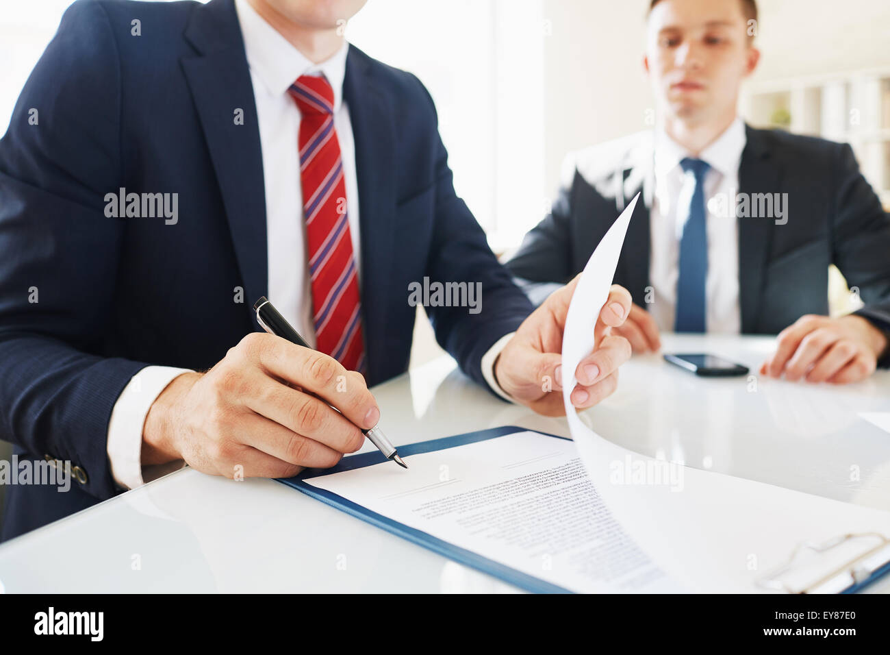Businessman signing contract with his partner near by Stock Photo - Alamy