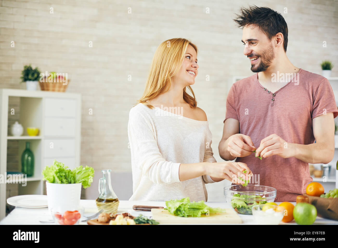 Young couple cooking breakfast together Stock Photo - Alamy