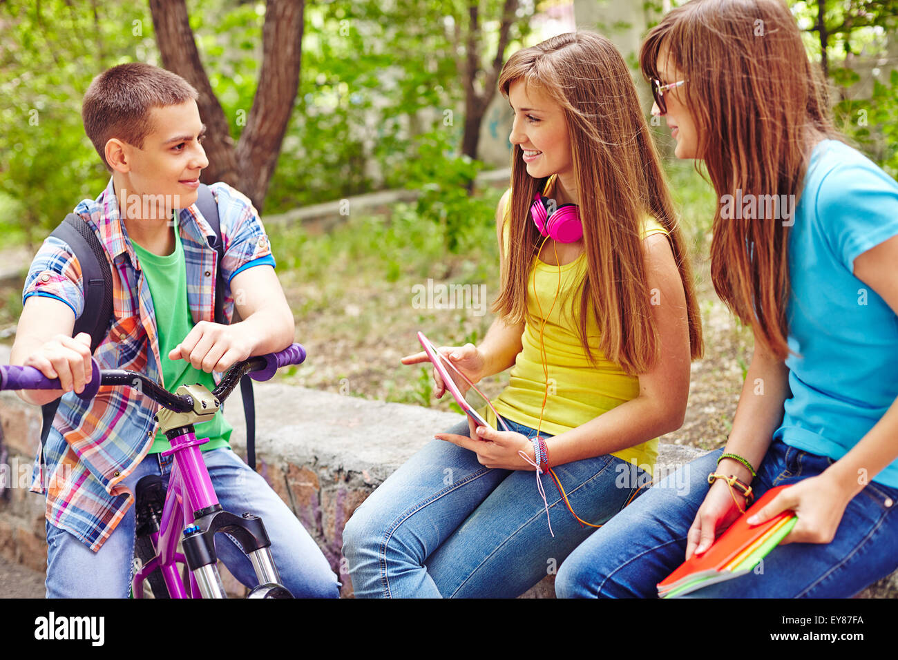 Friendly teenagers communicating in natural environment Stock Photo - Alamy