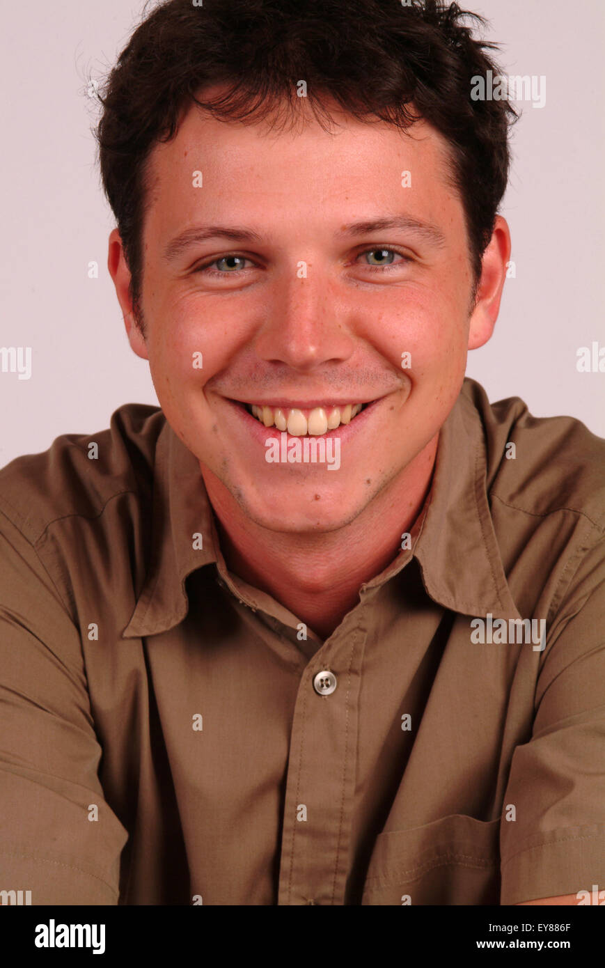 Studio portrait of young man smiling Stock Photo - Alamy