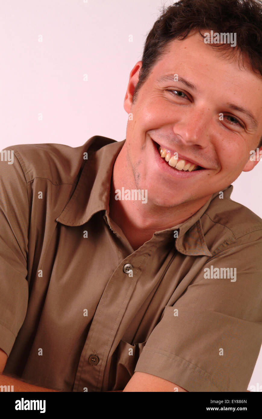 Studio portrait of young man smiling Stock Photo - Alamy