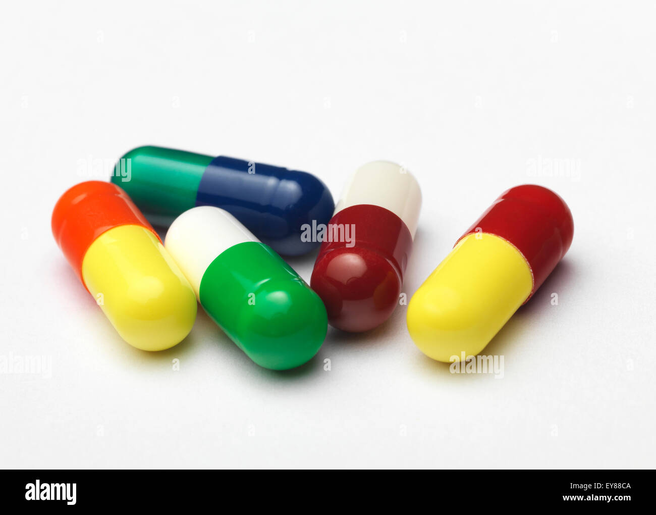 Capsules on white background Stock Photo - Alamy