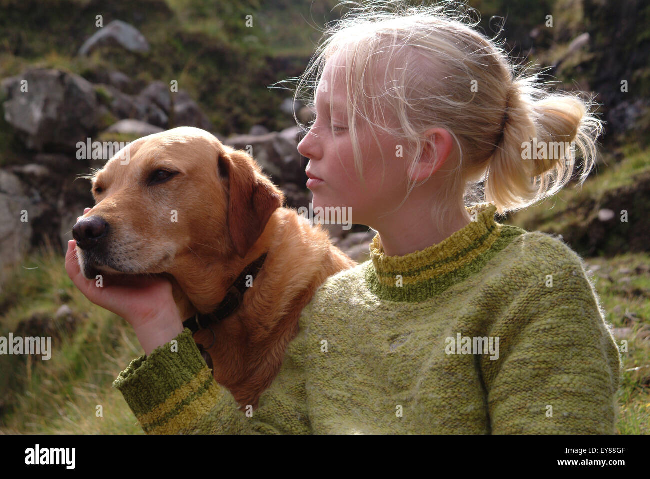 Young girl sitting outdoors with her labrador dog Stock Photo - Alamy