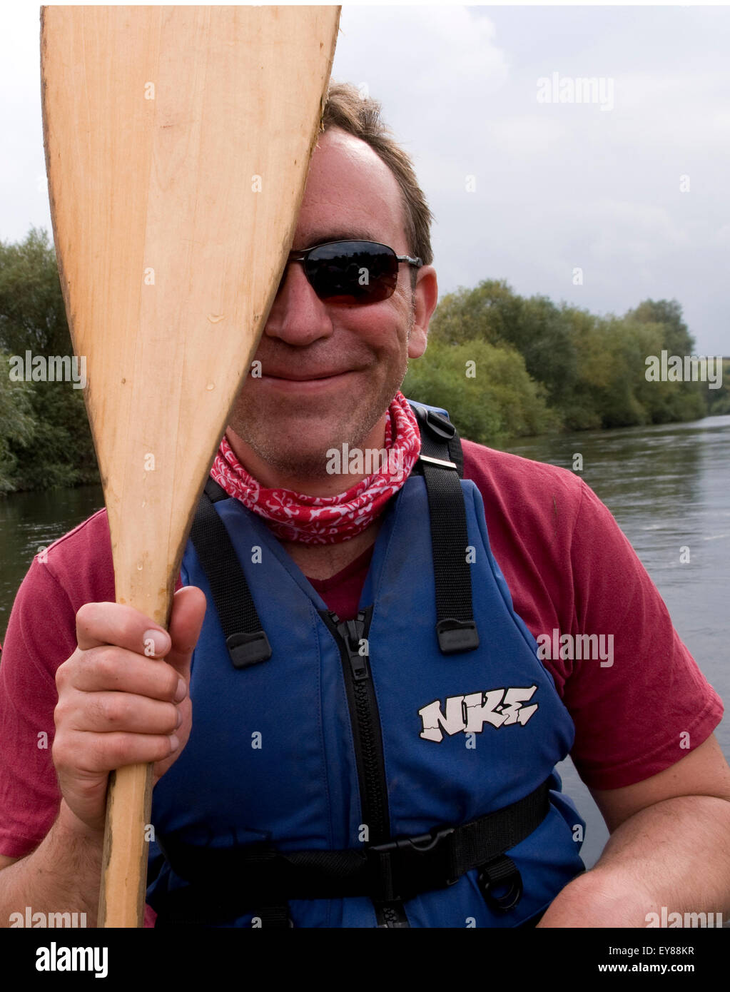 Happy smiling man wearing a life jacket Stock Photo - Alamy