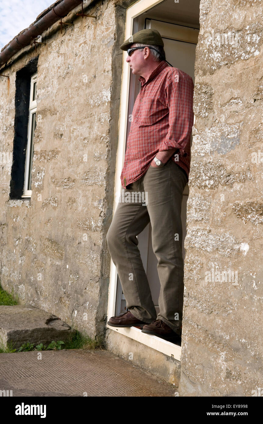 Side view of man standing in a doorway Stock Photo - Alamy