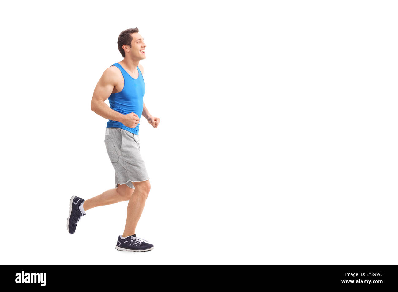 Full length profile shot of a young man in sportswear running and ...
