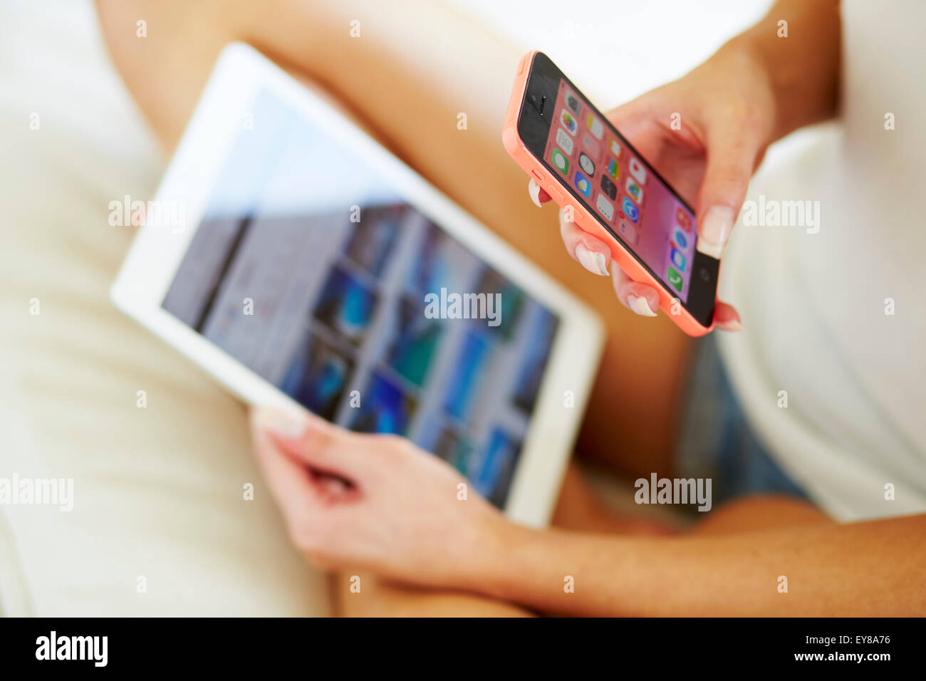 Closeup of a girl using an iPad and an iPhone Stock Photo - Alamy