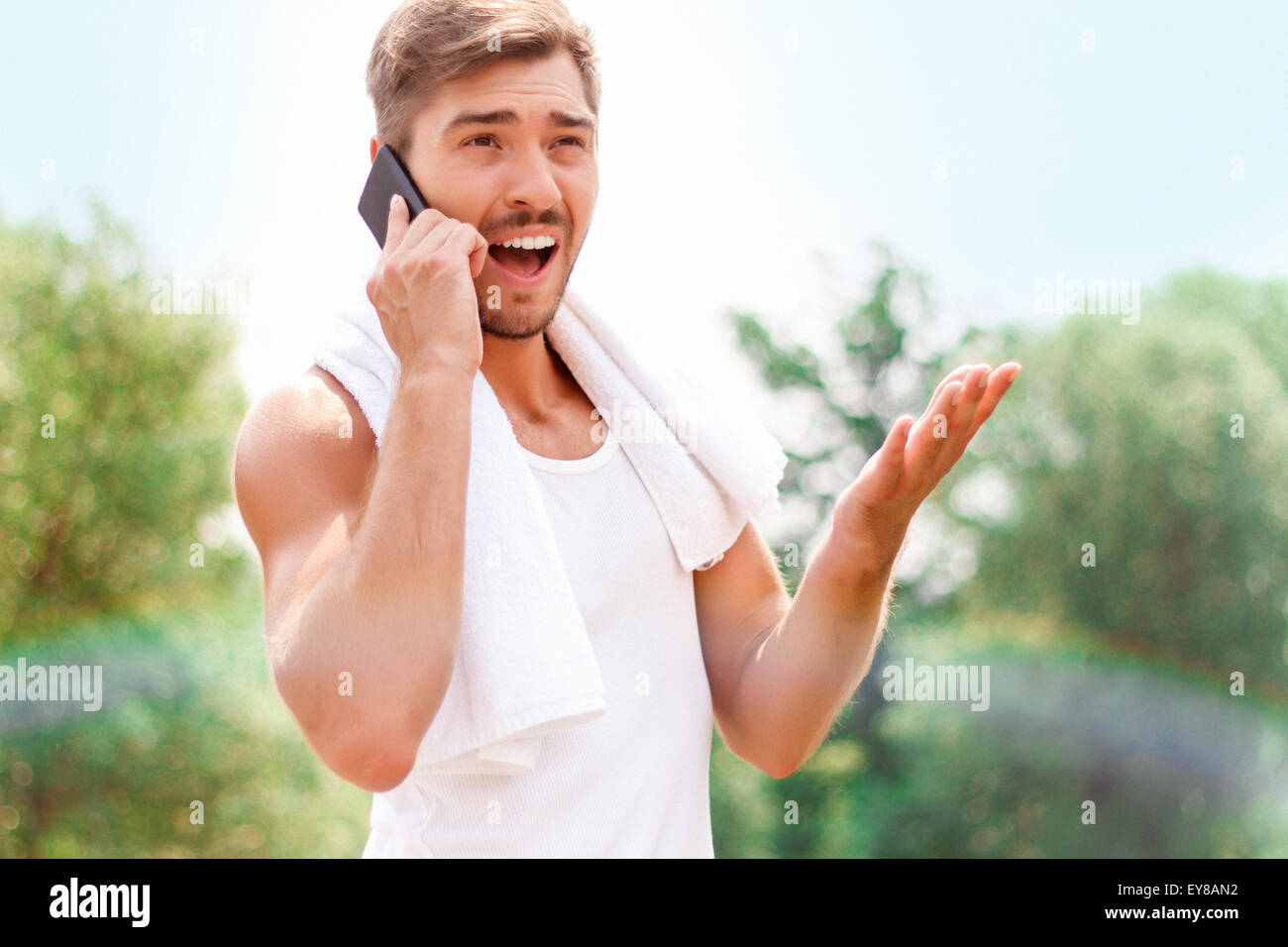 Smiling guy talking on phone Stock Photo - Alamy