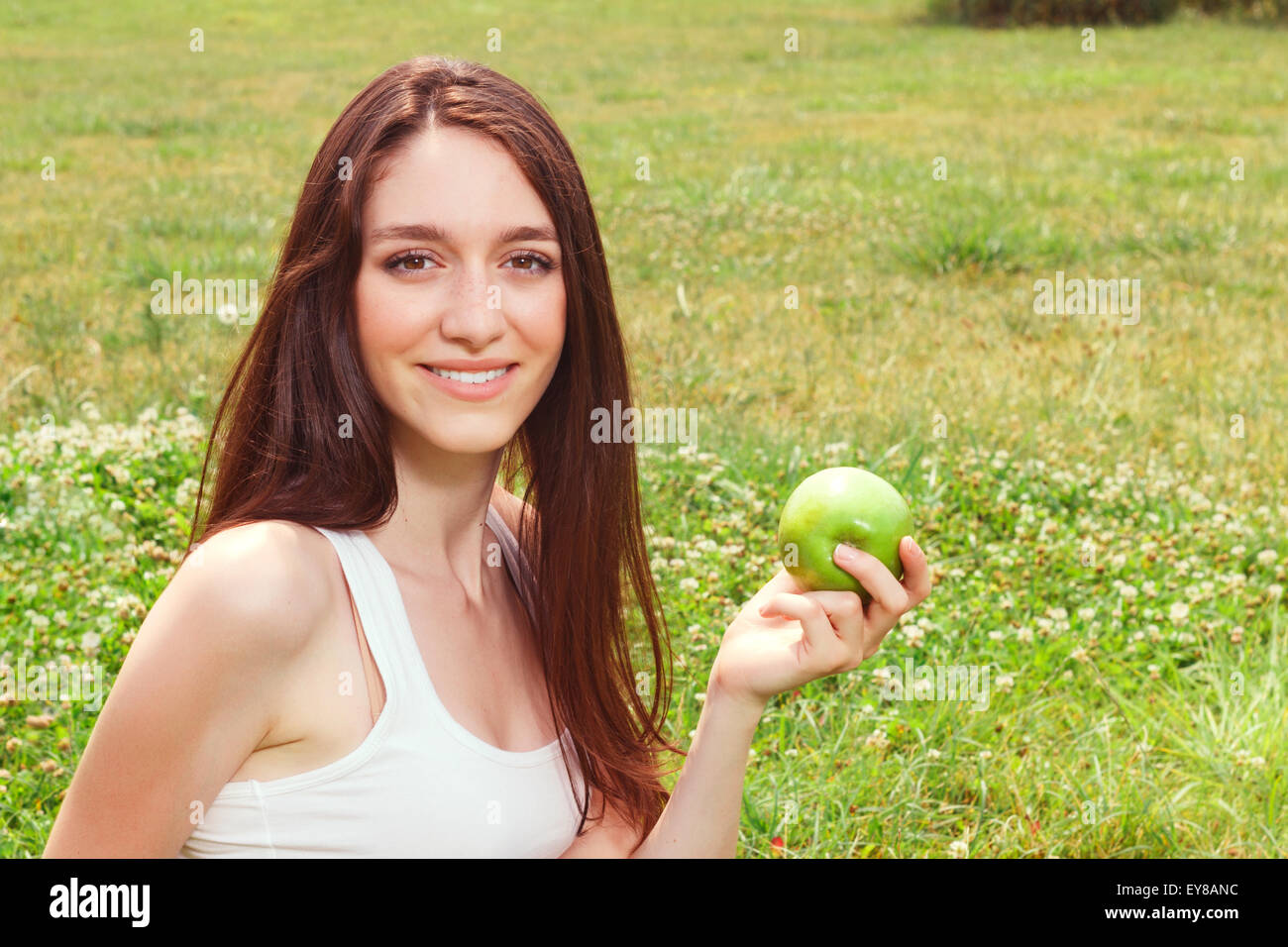 Nice young girl eating apple Stock Photo - Alamy