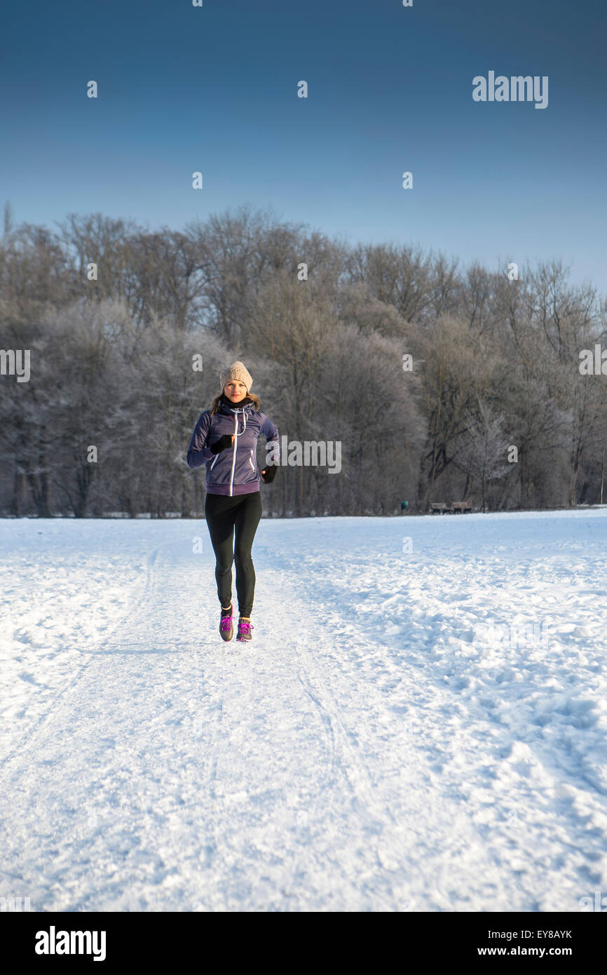Young woman jogging in winter landscape Stock Photo - Alamy