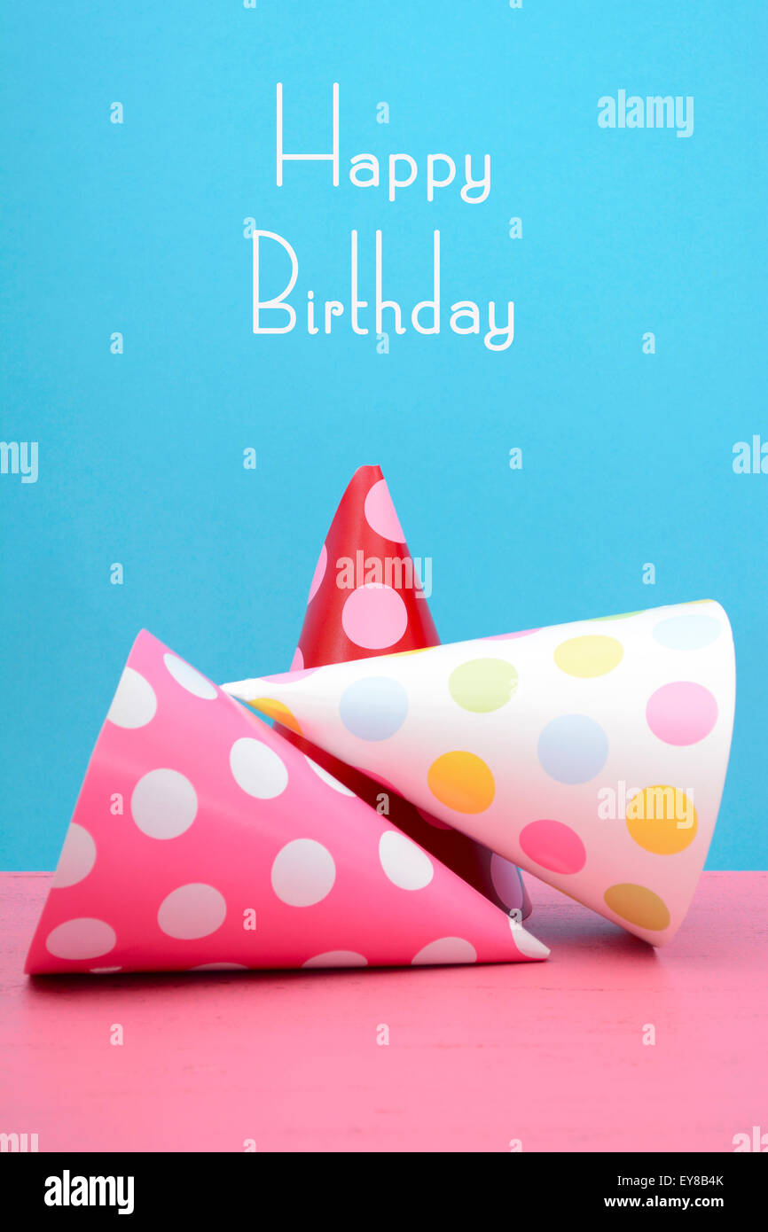 Bright party polka dot party hats on modern pink and blue background ...