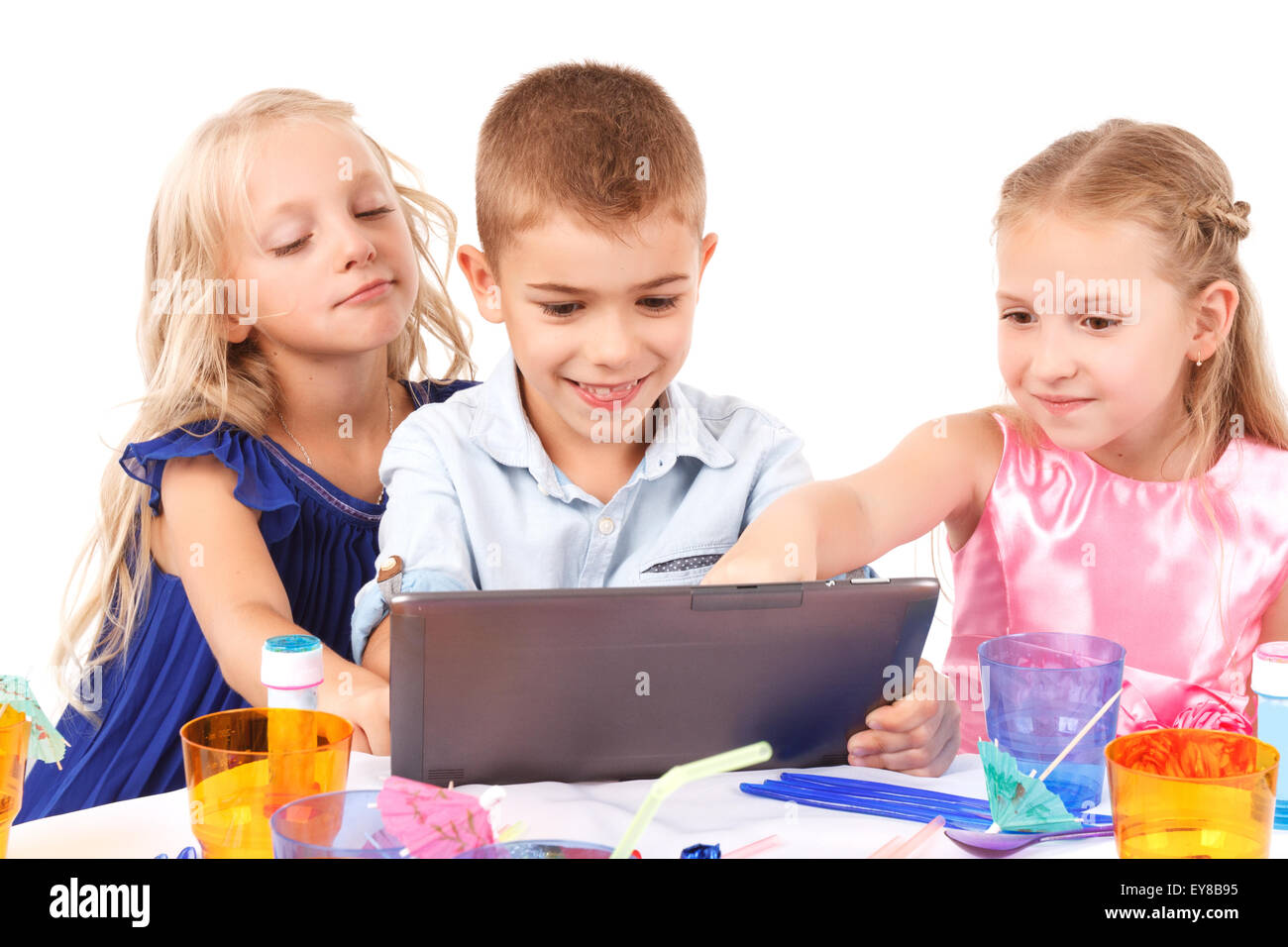 Playful children sitting with laptop Stock Photo - Alamy