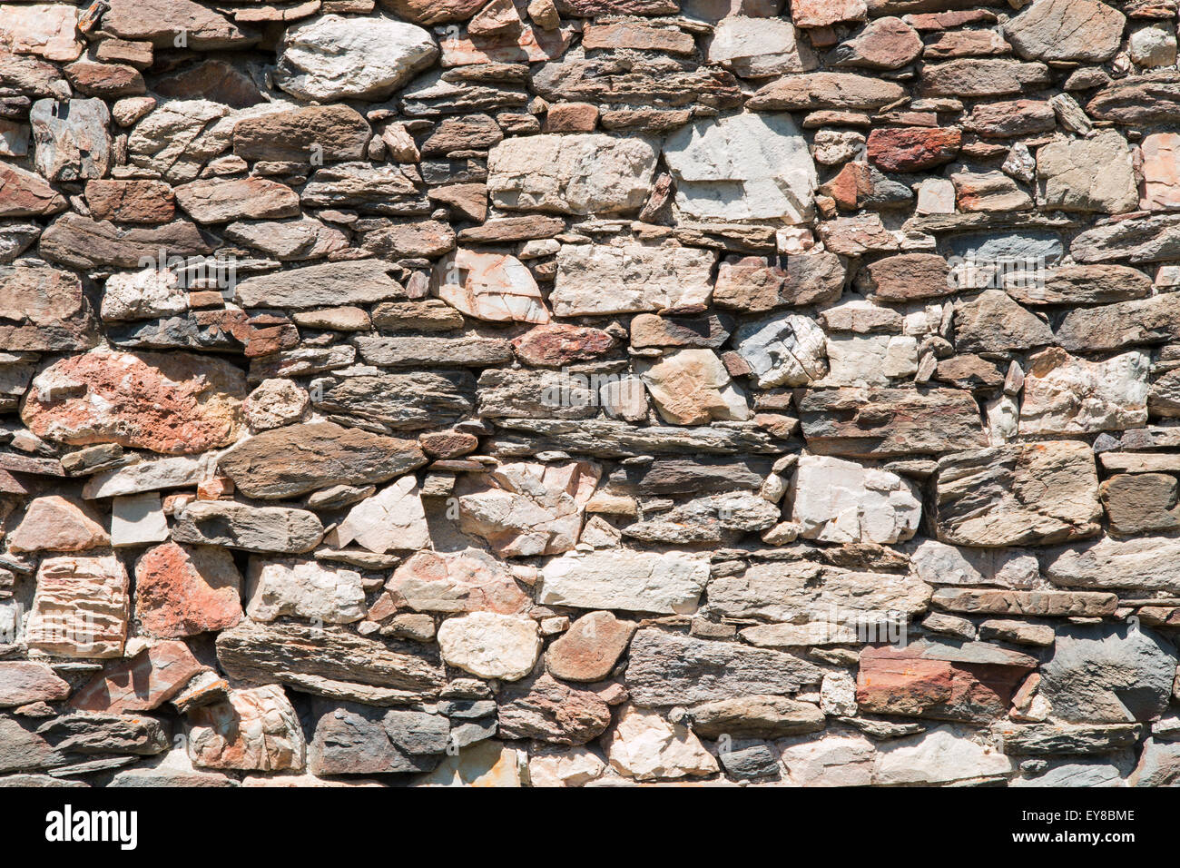 Old wall made of irregular shaped stones Stock Photo - Alamy
