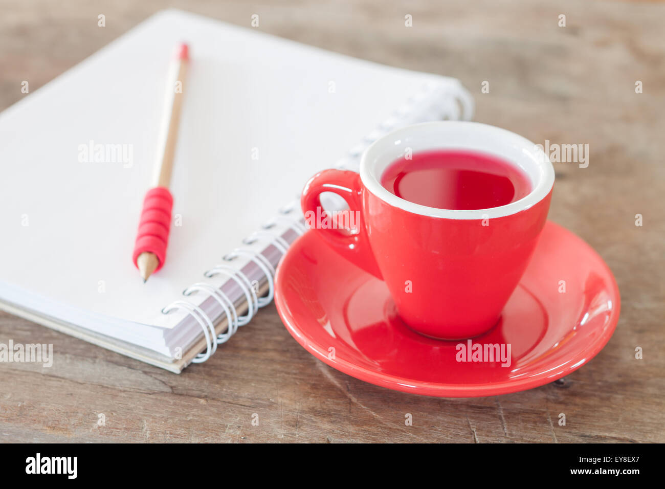 Red mug with open notebook, stock photo Stock Photo - Alamy