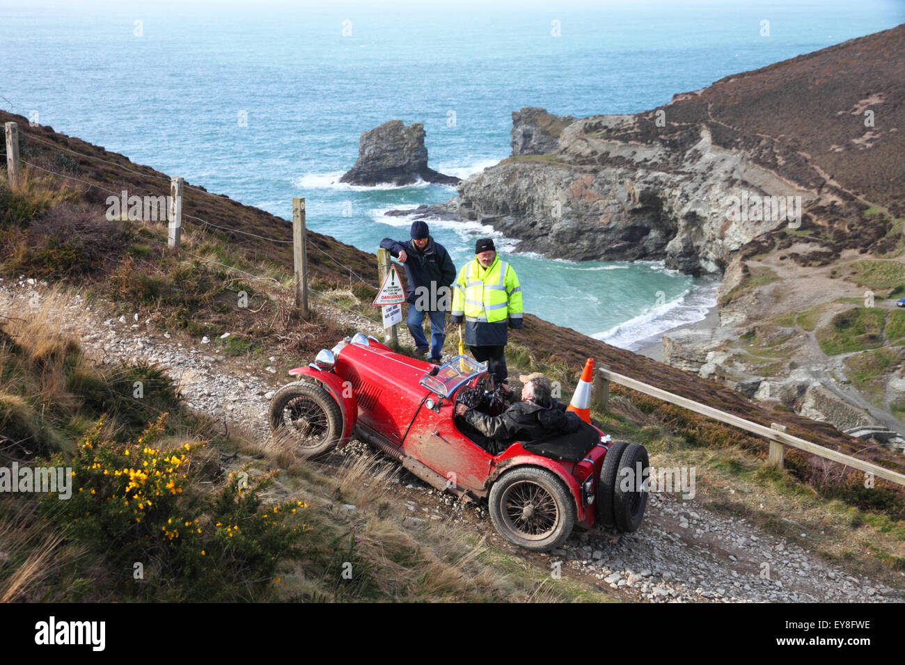 A red MG open top car takes part in a hill climb event at a clifftop ...