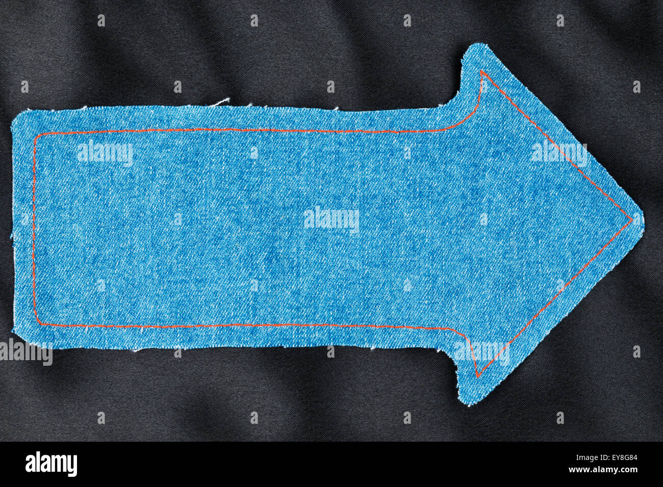 Pointer made of denim fabric with yellow stitching on black silk, with ...