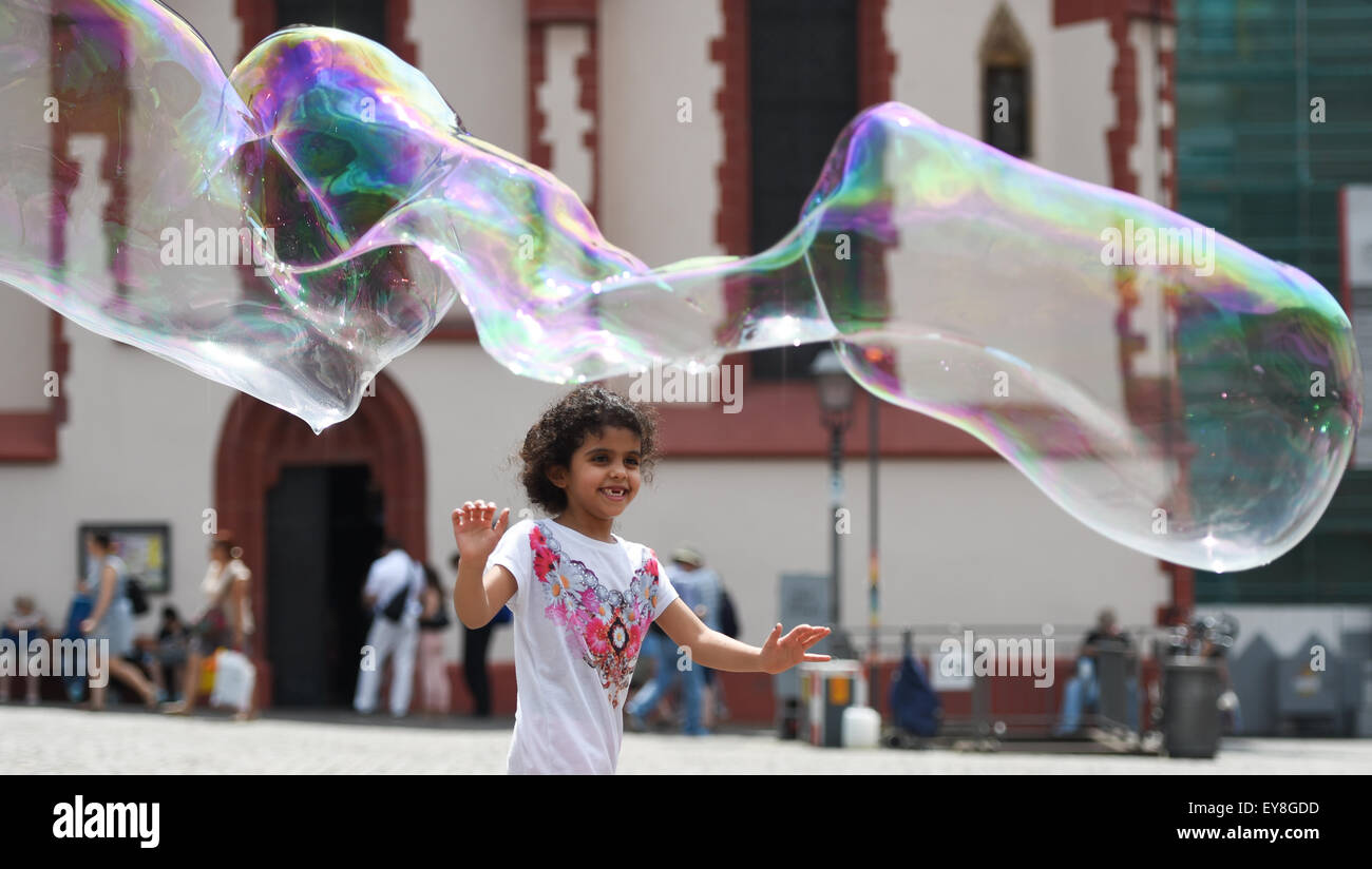 A girl chases after a giant soap bubble at the Roemerberg in Frankfurt am Main, Germany, 24 July ...