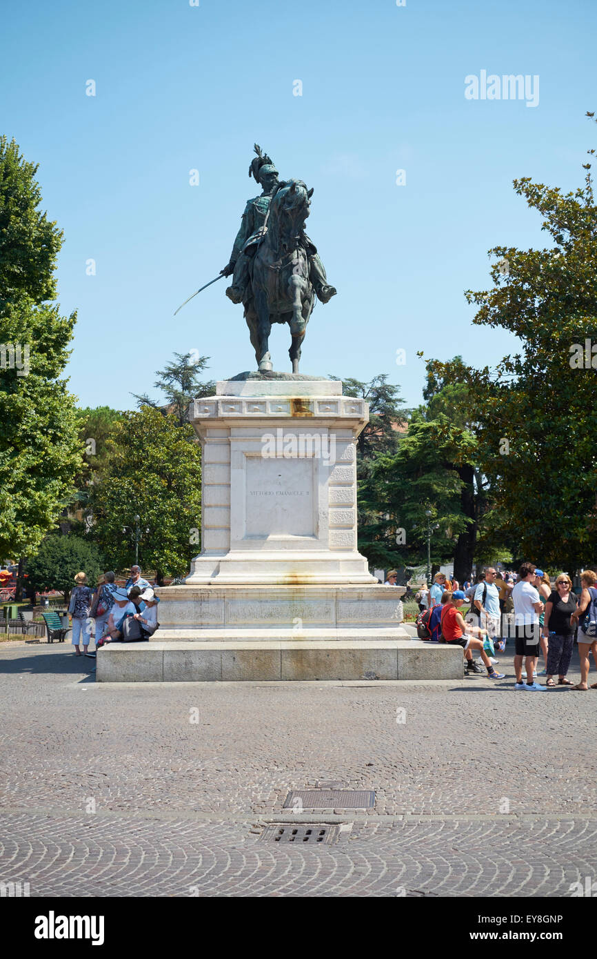 VERONA, ITALY - JULY 13: Tourists resting by statue of Victor Emanuel ...
