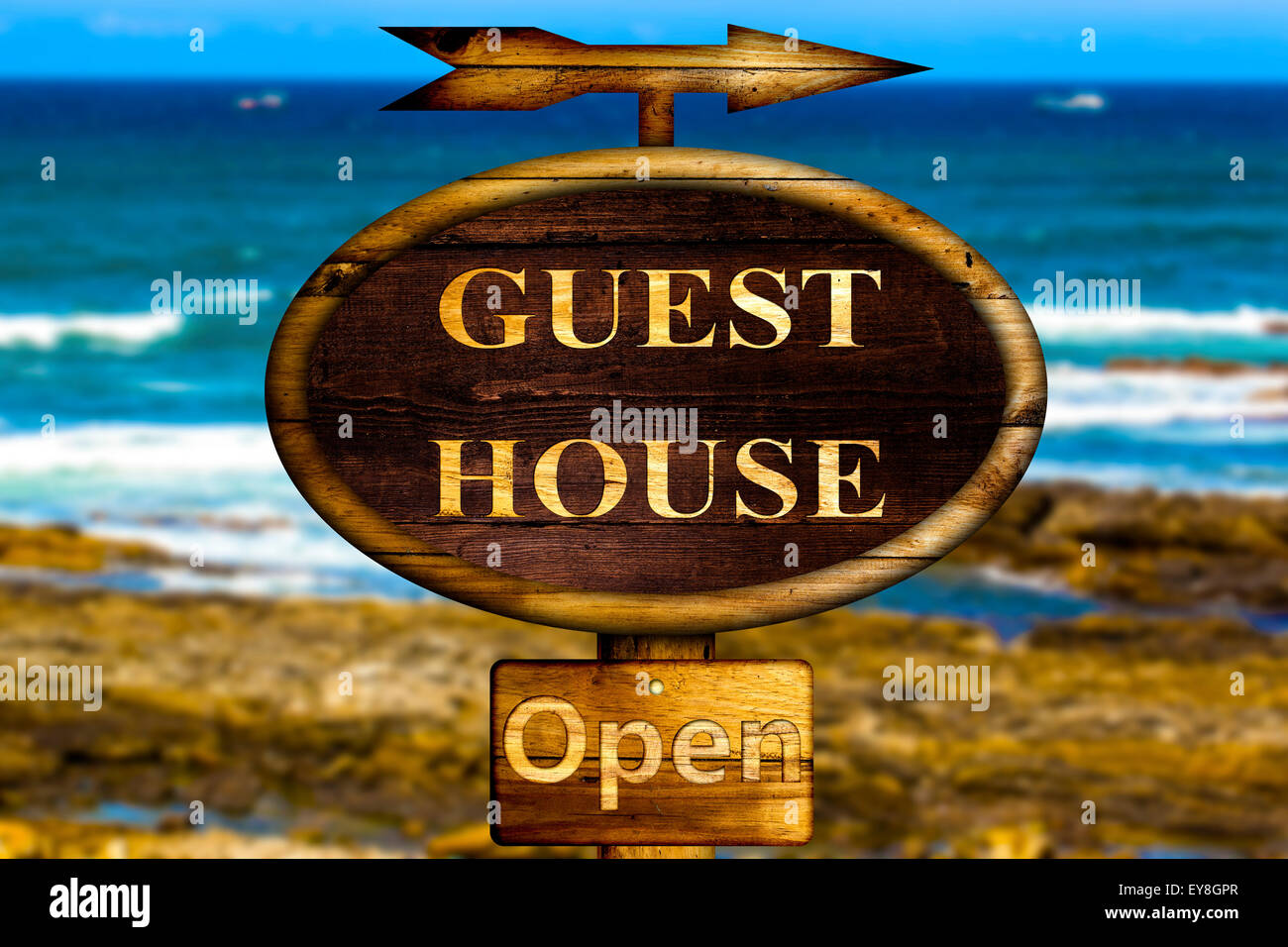 Wooden Guest house sign with a ocean background Stock Photo - Alamy