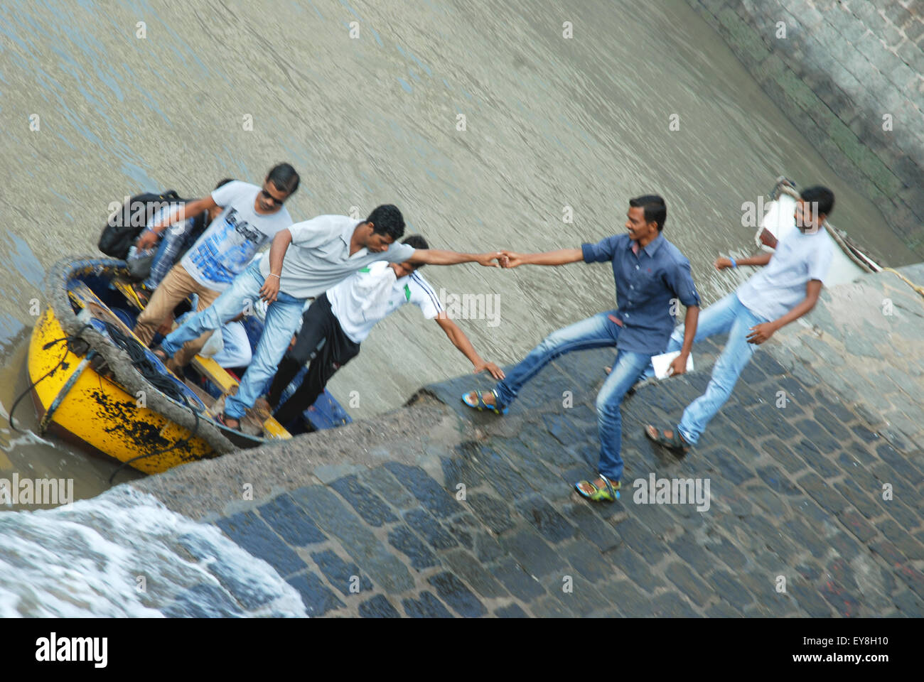 Man helping another man climb hi-res stock photography and images - Alamy
