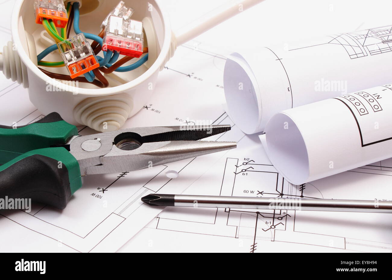 Work tools, rolls of diagrams and cable connections in electrical box ...