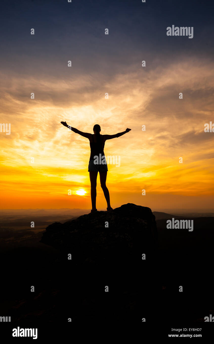 single adult woman silhouette on rock Stock Photo - Alamy