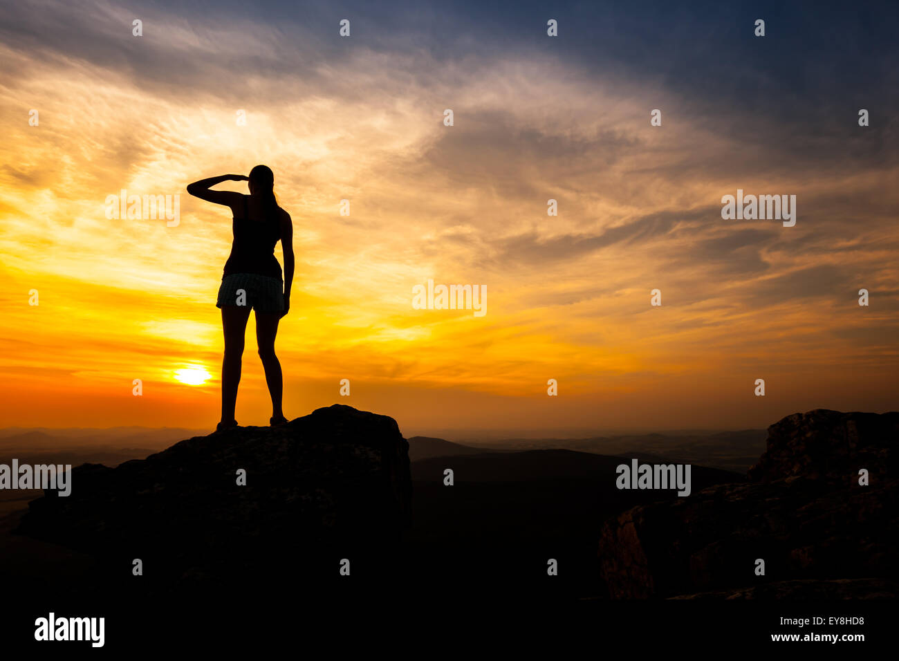 single adult woman silhouette on rock Stock Photo - Alamy