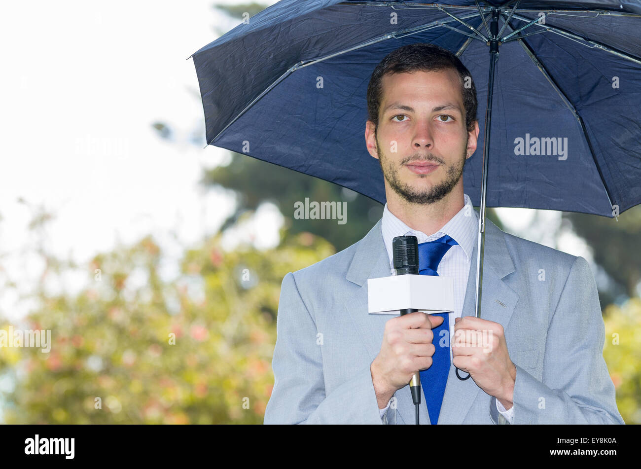 Successful handsome male journalist wearing light grey suit working in ...