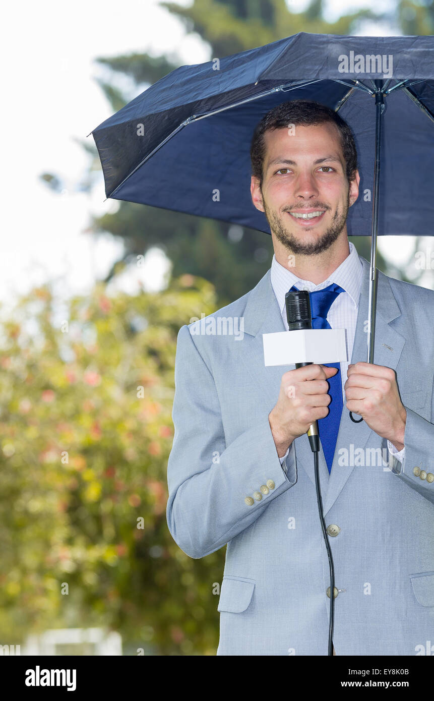 Successful handsome male journalist wearing light grey suit working in ...