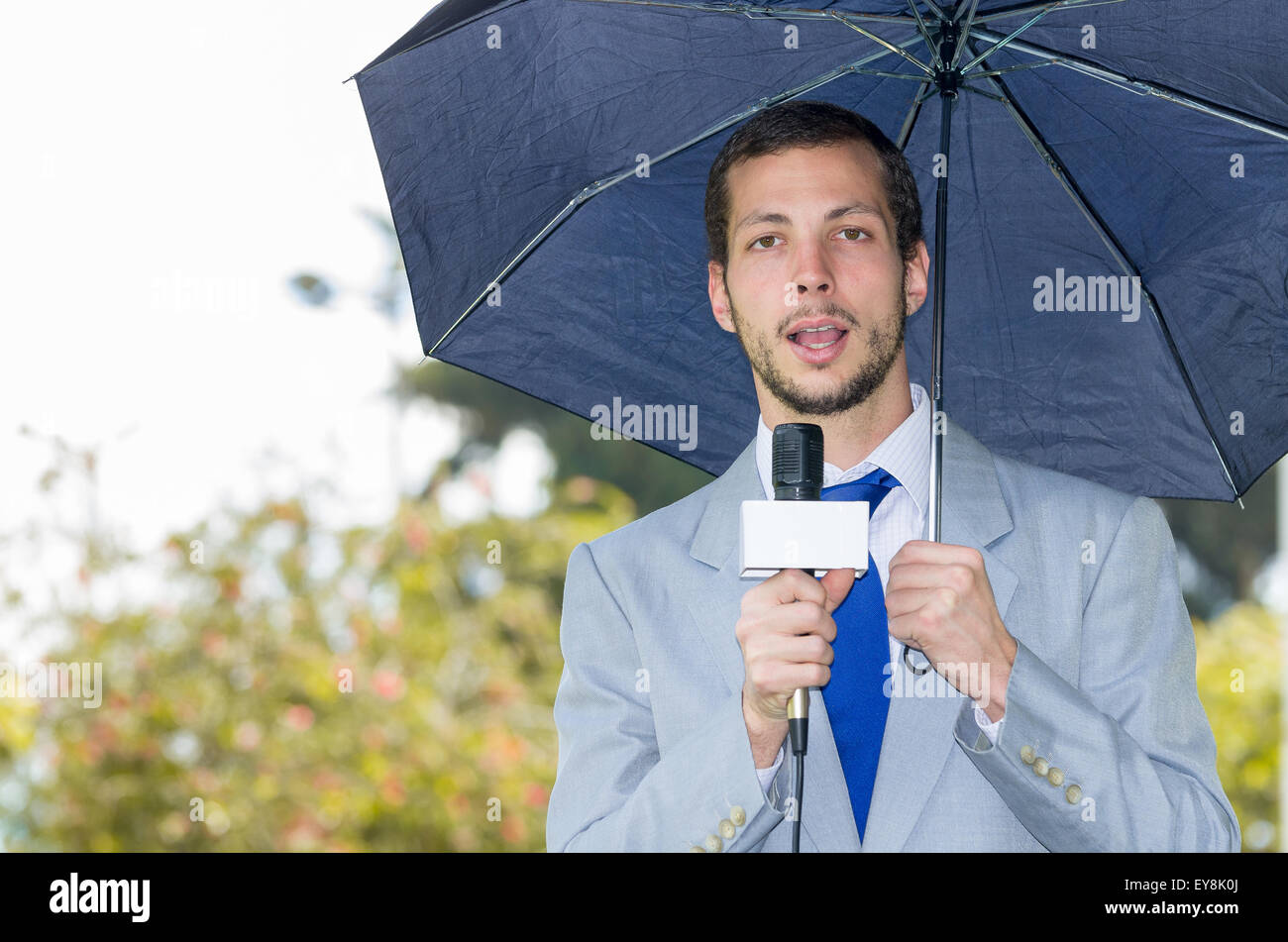 Successful handsome male journalist wearing light grey suit working in ...
