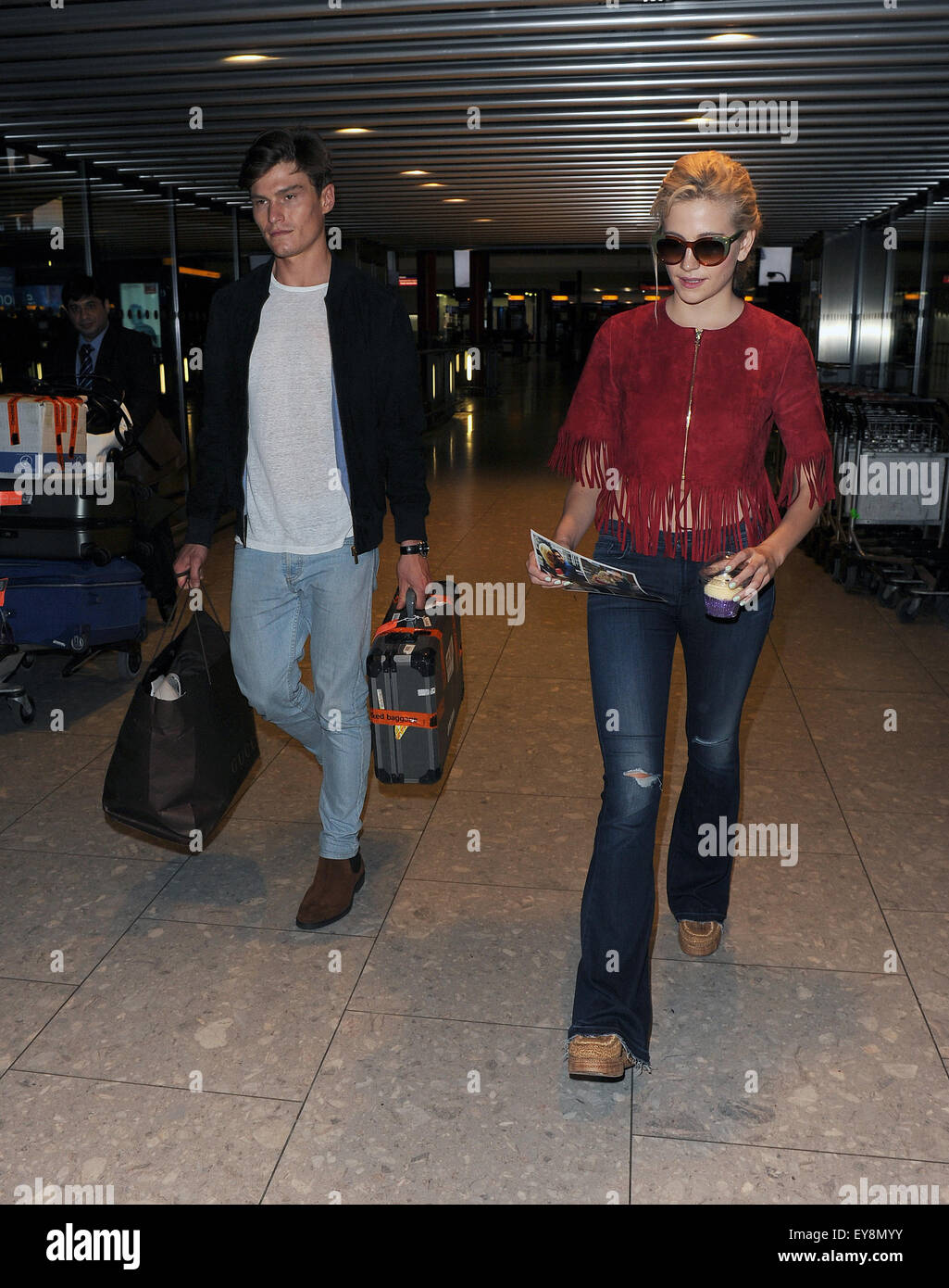 Pixie Lott and her boyfriend Oliver Cheshire arrive at Heathrow Airport ...