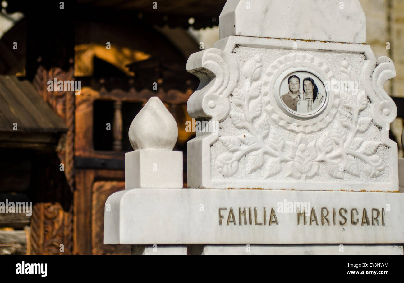 In a serene cemetery, a weathered cross marks the resting place ...