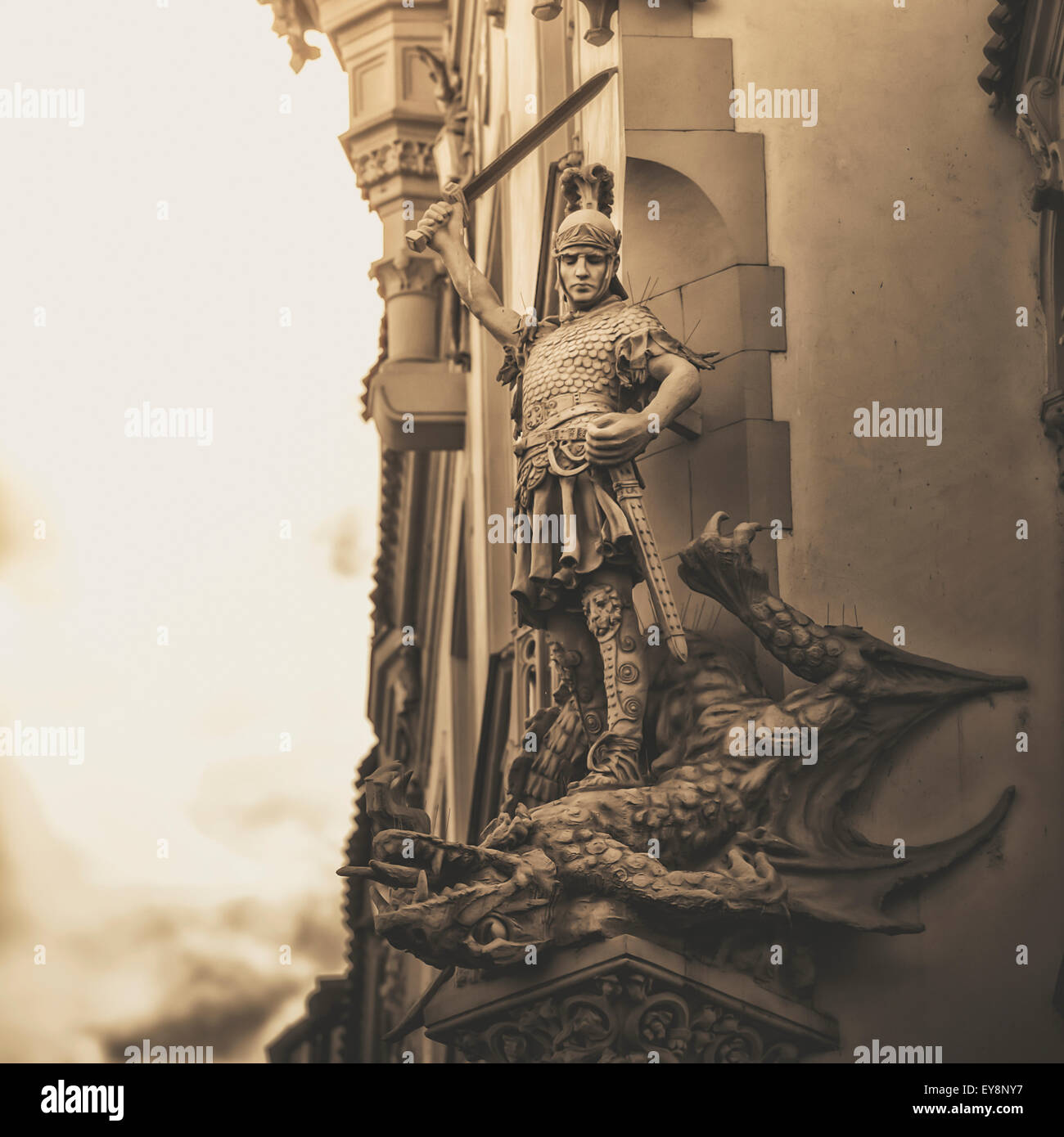 Statue on the side of a building of a warrior slaying a dragon; Prague ...