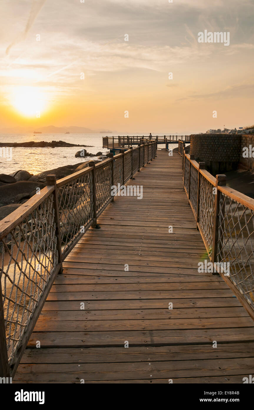 Wooden boardwalk with railing along the water; Xiamen, Fujian, China ...