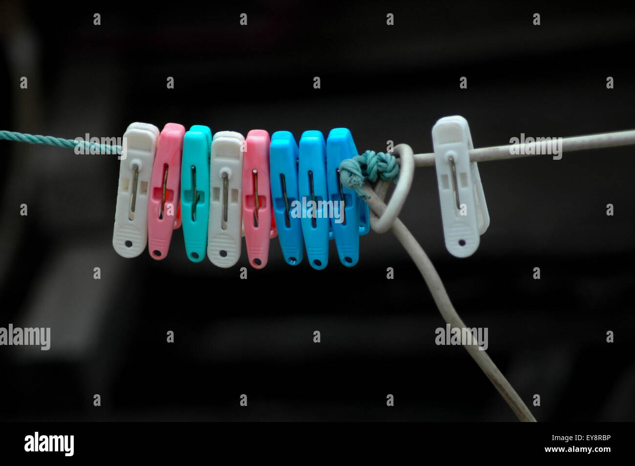 Plastic clothesline clamps Stock Photo - Alamy