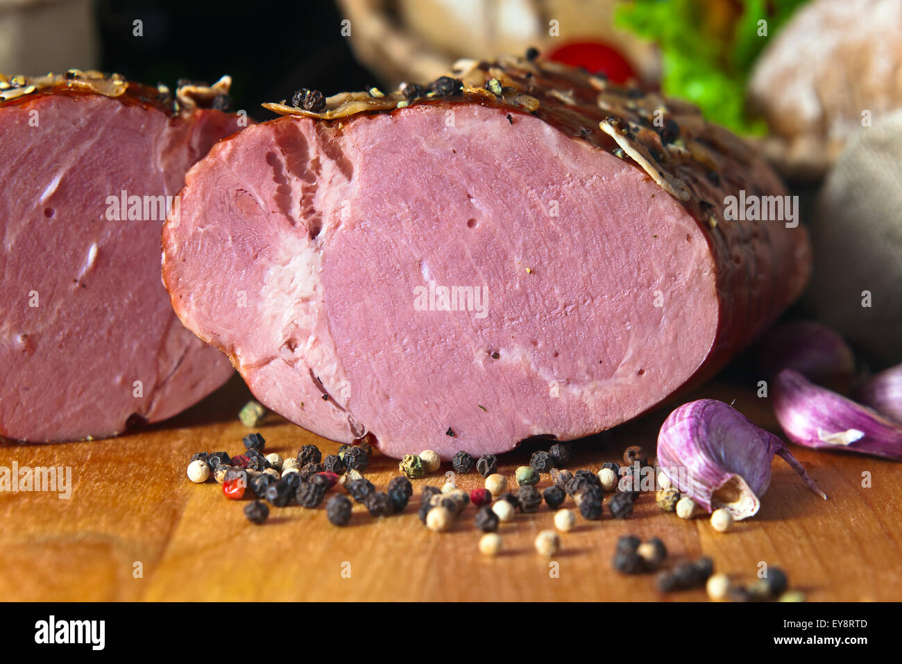 smoked meat with pepper on a kitchen table Stock Photo - Alamy