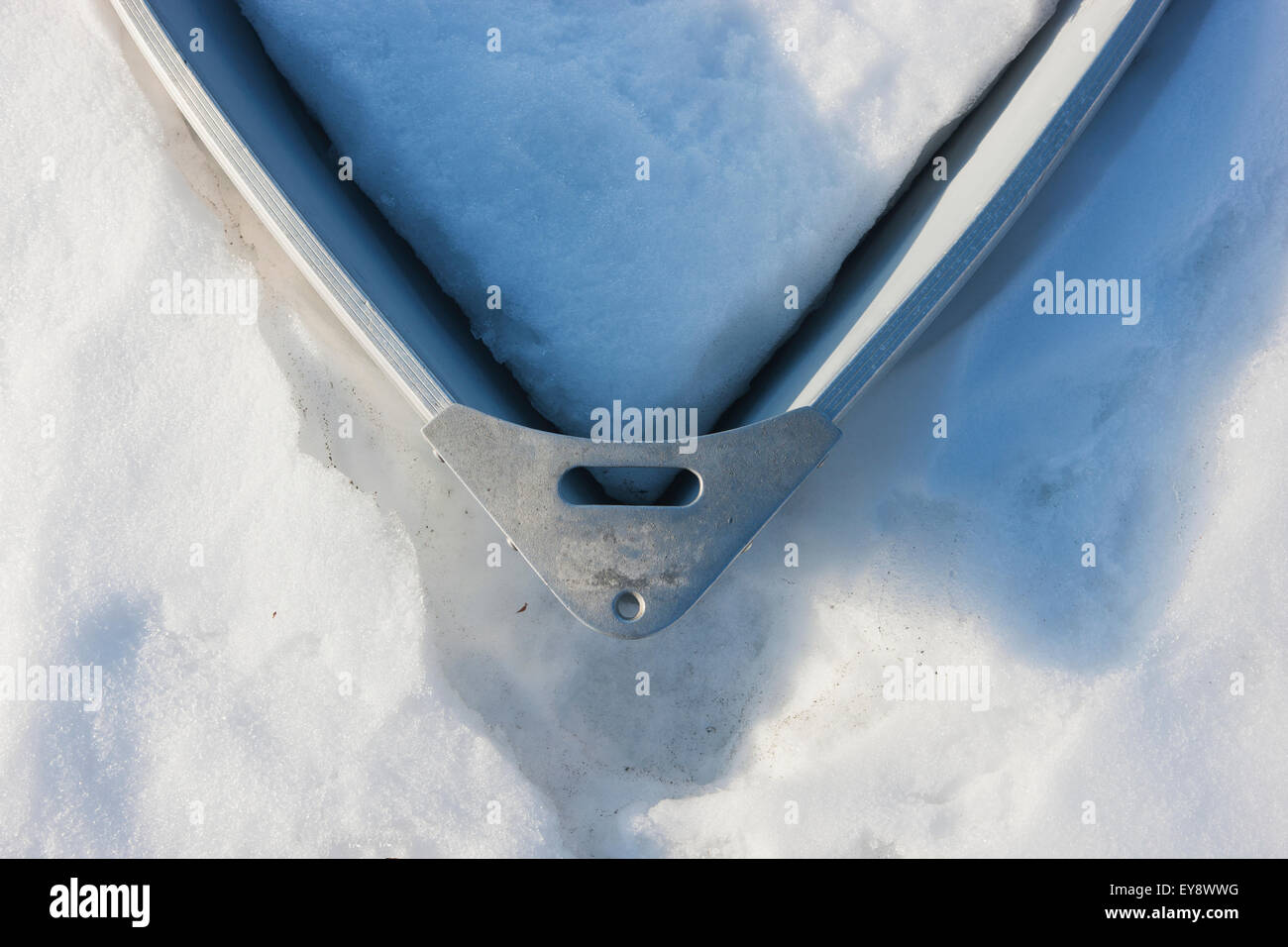 Bow of boat filled with and surrounded by snow; Nome, Alaska, United ...