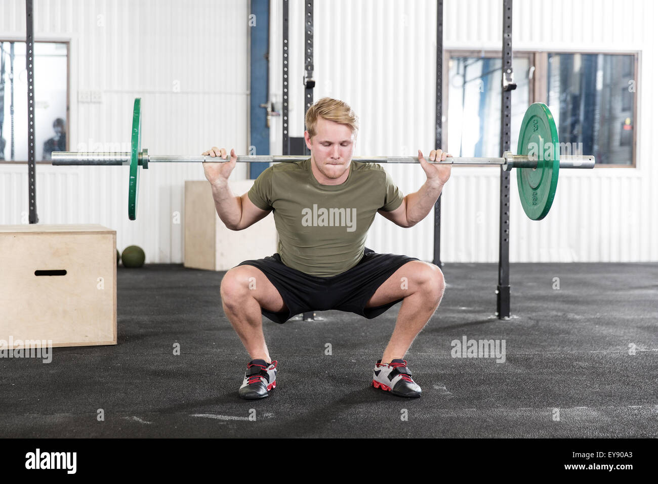 Squats training at fitness gym center Stock Photo - Alamy