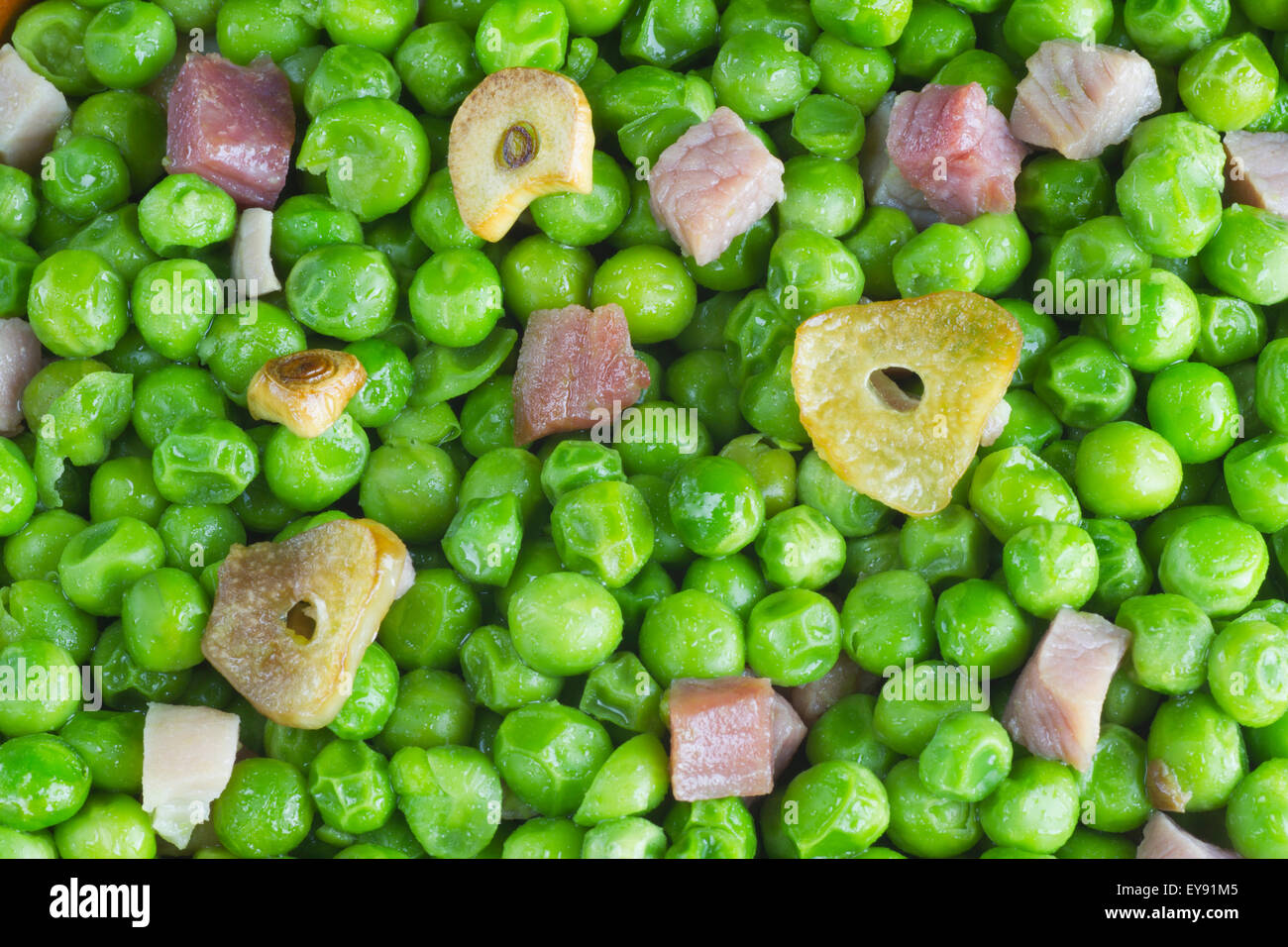 Peas with ham and garlic background Stock Photo - Alamy